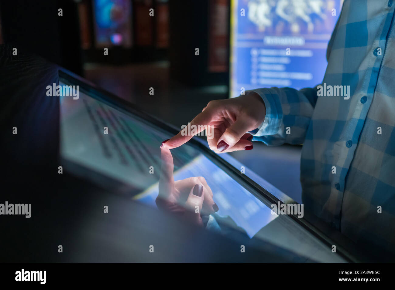 Woman using multimedia touchscreen display of interactive kiosk Stock ...