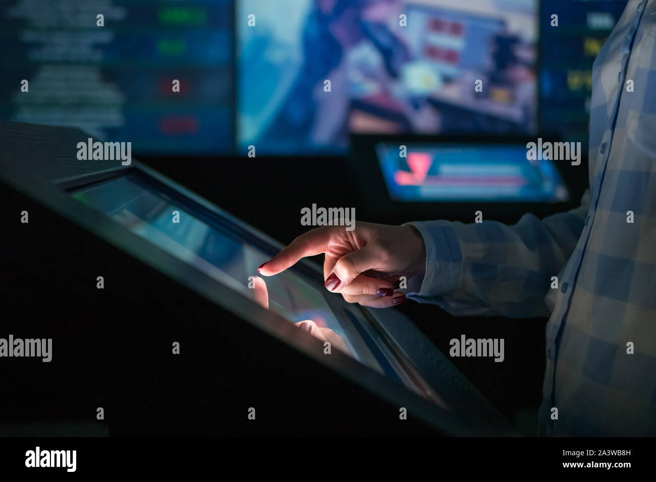 Woman using multimedia touchscreen display of interactive kiosk Stock ...