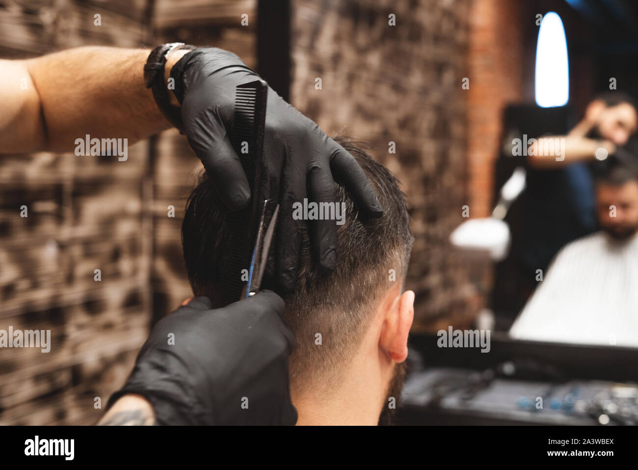 Haircut head in barbershop. Barber cuts the hair on the head of the ...