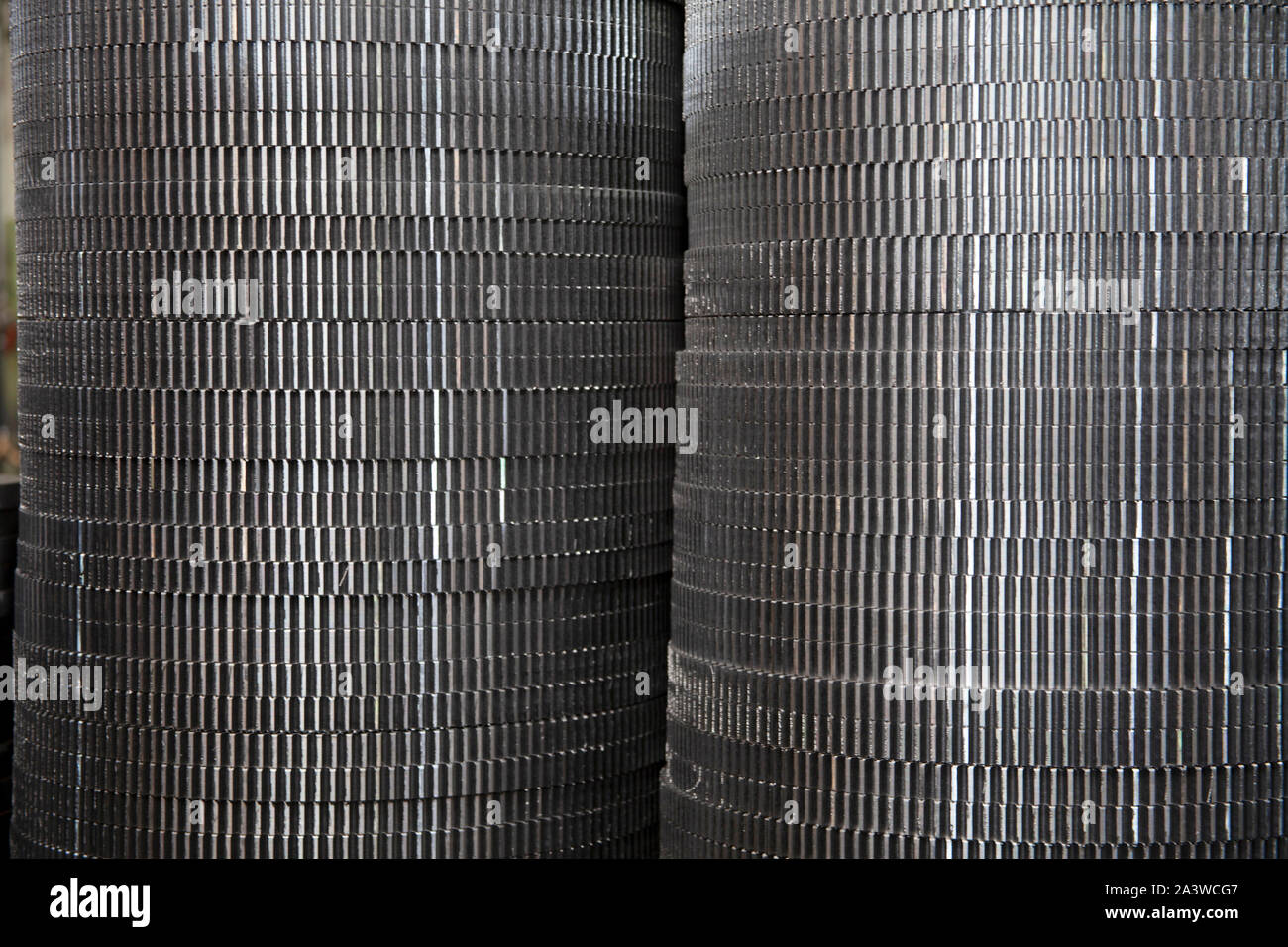 stacked steel pulleys inside factory Stock Photo - Alamy