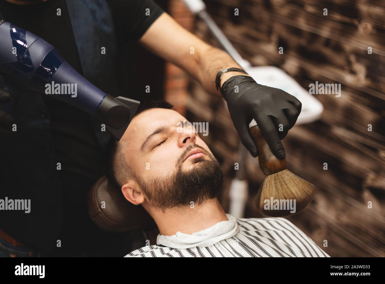 Shaving a beard in a barbershop with a dangerous razor. Barber Shop ...