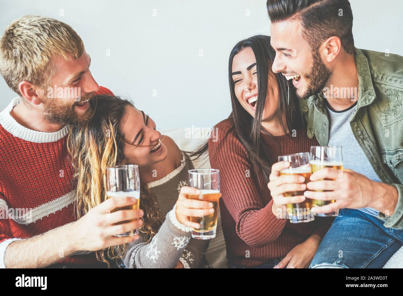 Group of happy friends cheering with beer at home - Millennial Young ...