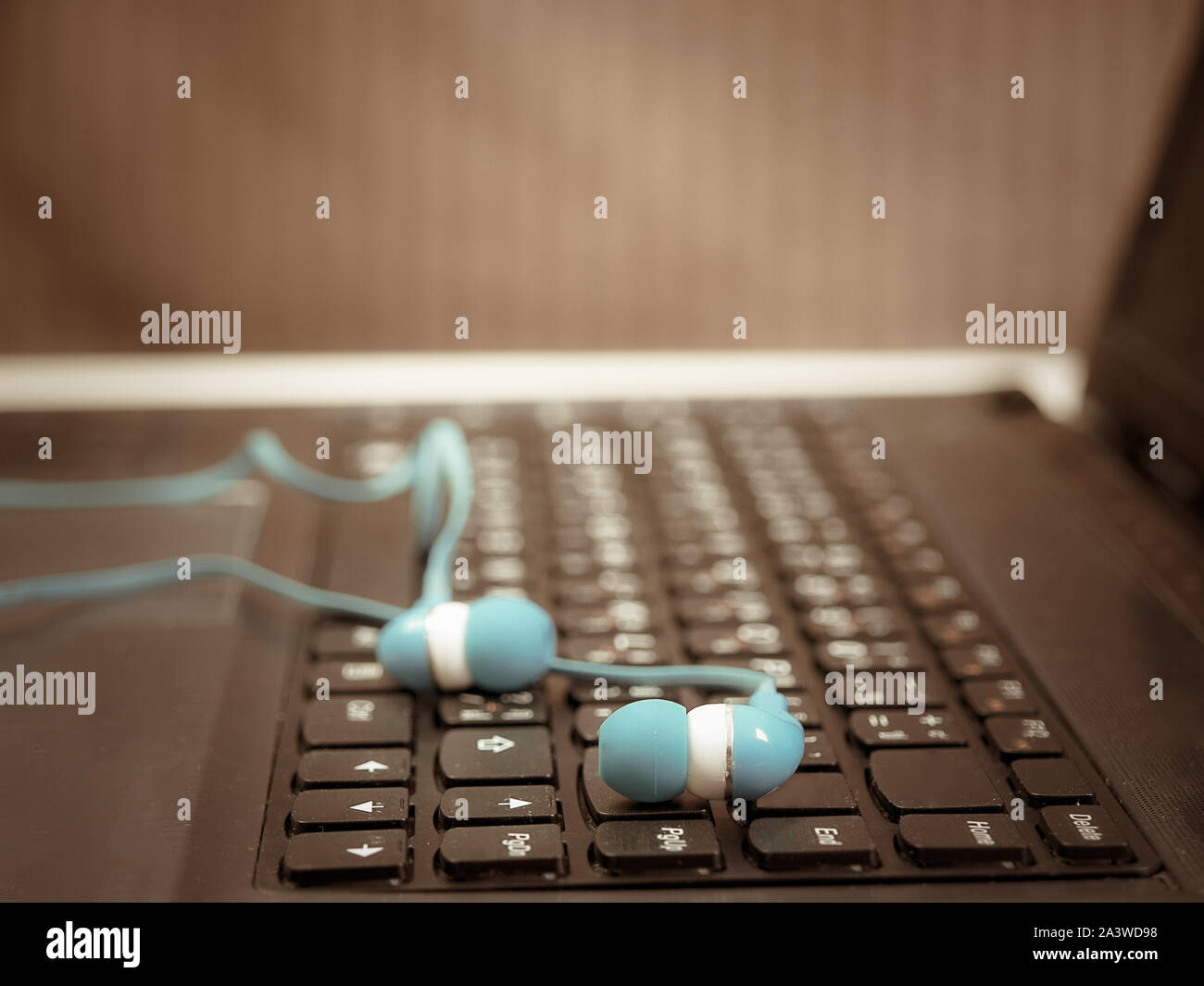 Laptop computer with headset on keyboard (vintage Stock Photo - Alamy