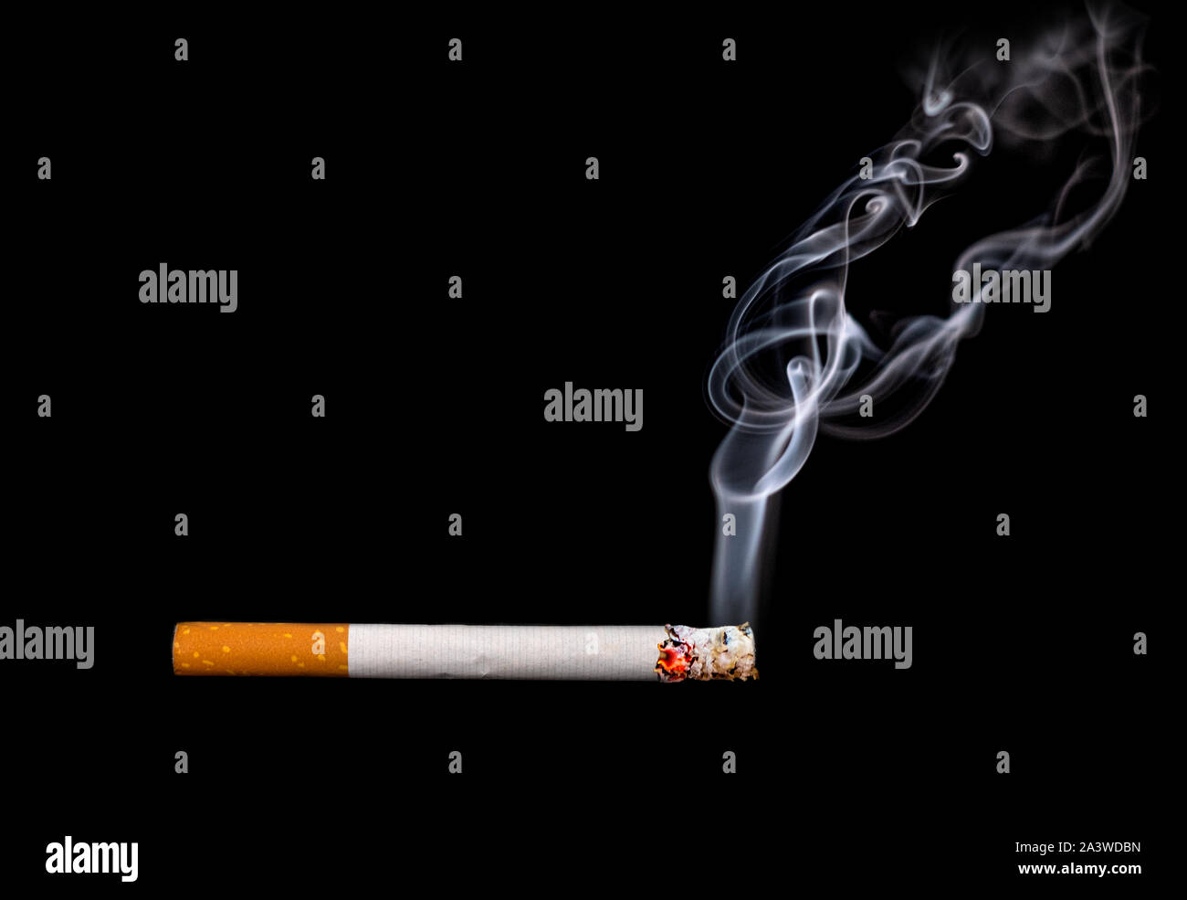 Close up of a cigarette with smoke showing at black background Stock ...