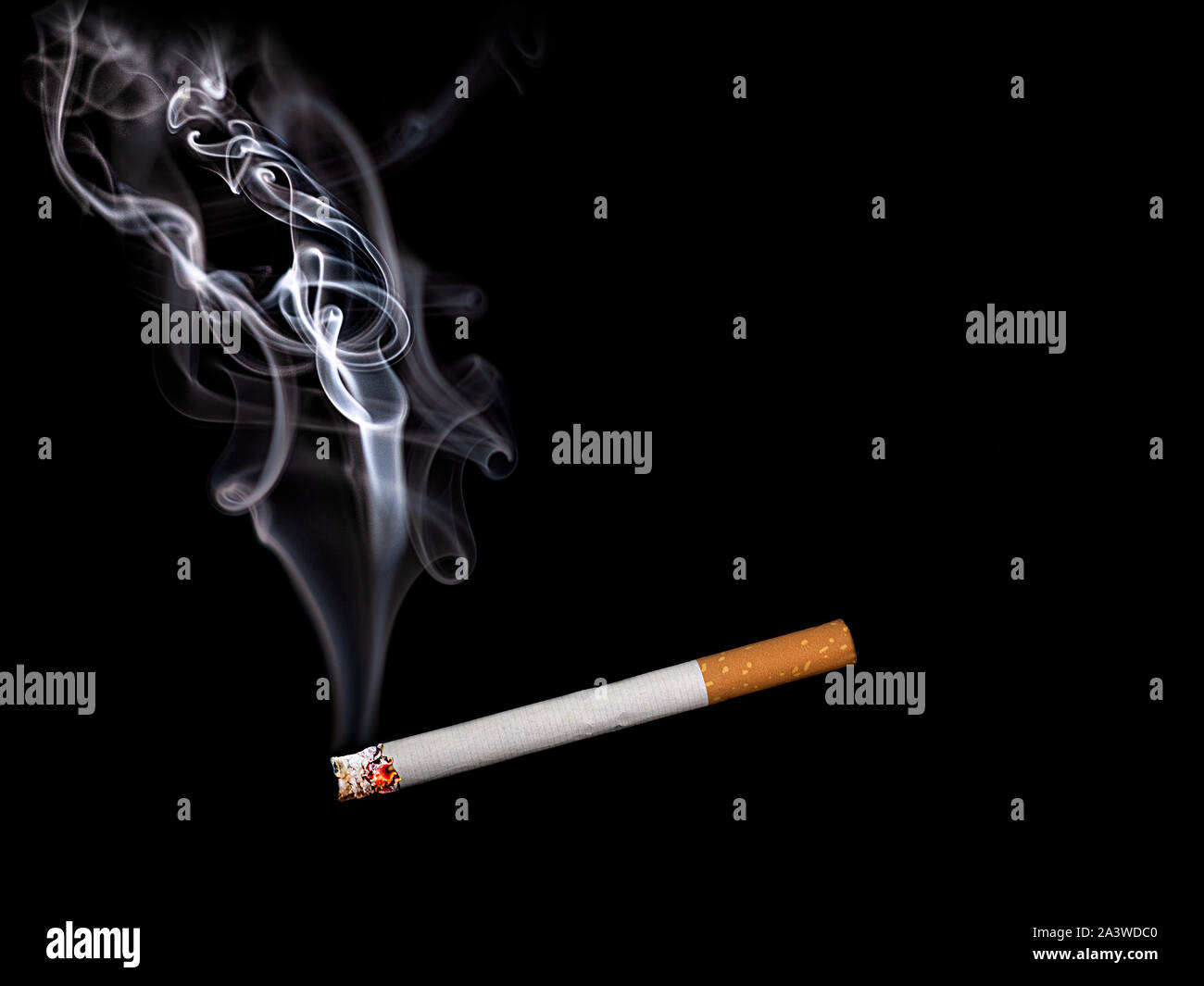 Close up of a cigarette with smoke showing at black background Stock ...