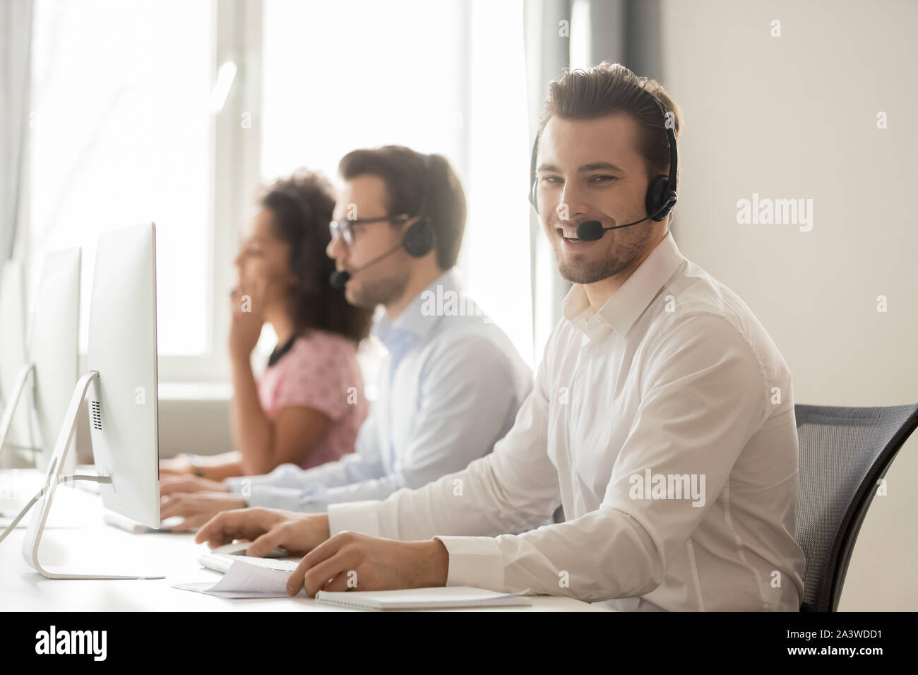 Millennial service phone operator sitting at workplace pose for camera ...