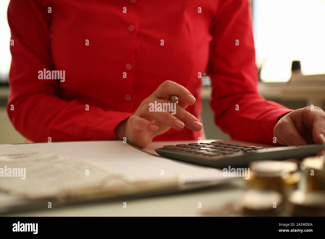 Worker counting with calculator indoor Stock Photo - Alamy