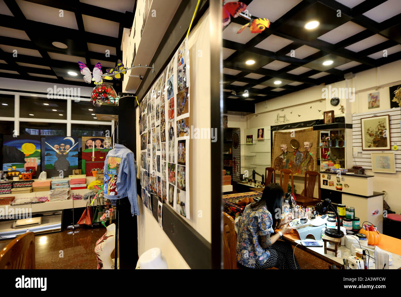 Yangon, Myanmar. 2nd Oct, 2019. Artist Nge Nge paints on shoes at her ...