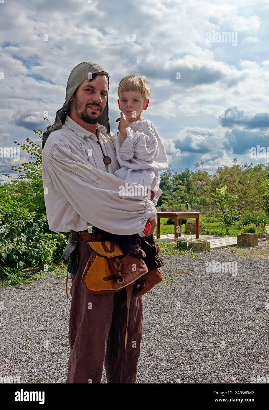 Medieval days re-enactment . A young "freeman farmer", father holds his ...