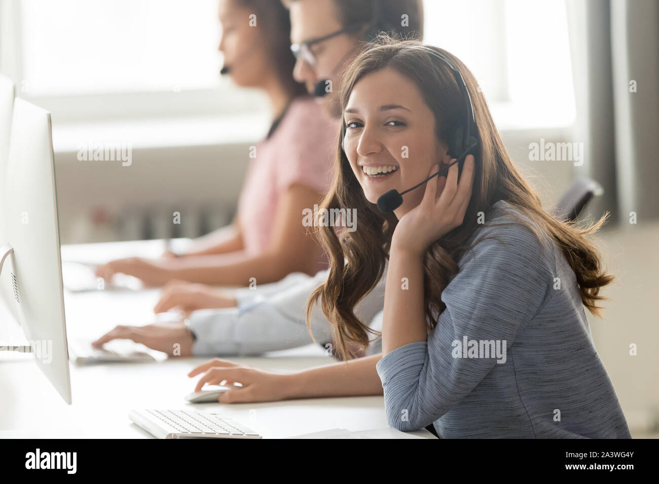 Call center employee female sitting at workplace pose for camera Stock ...