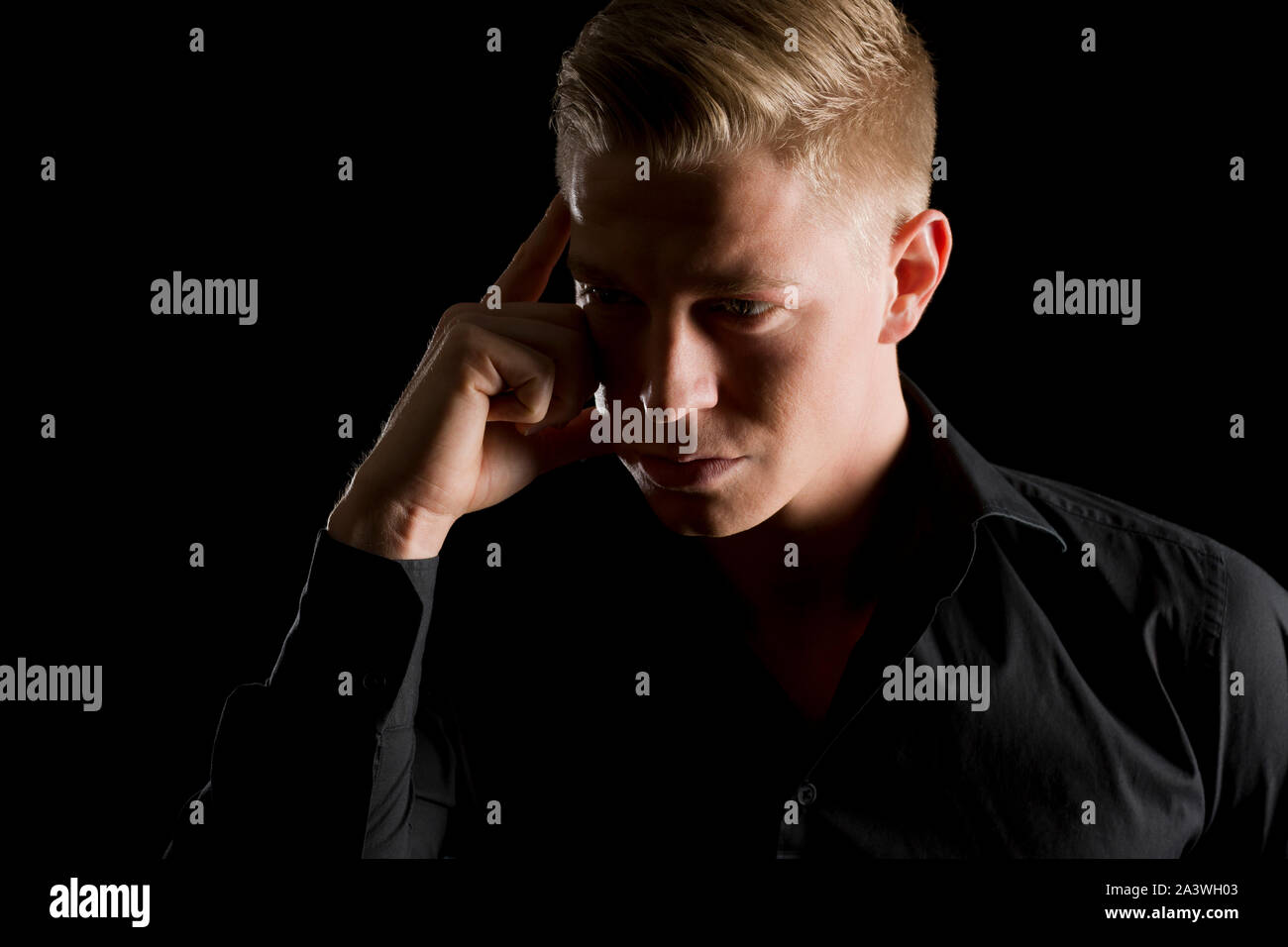 Low key portrait of attractive man looking aside Stock Photo - Alamy