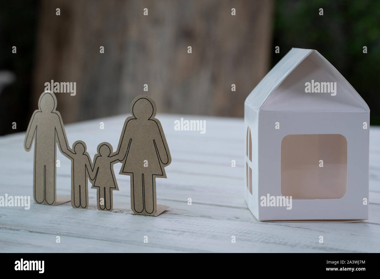 Happy paper family on white wood table Stock Photo - Alamy