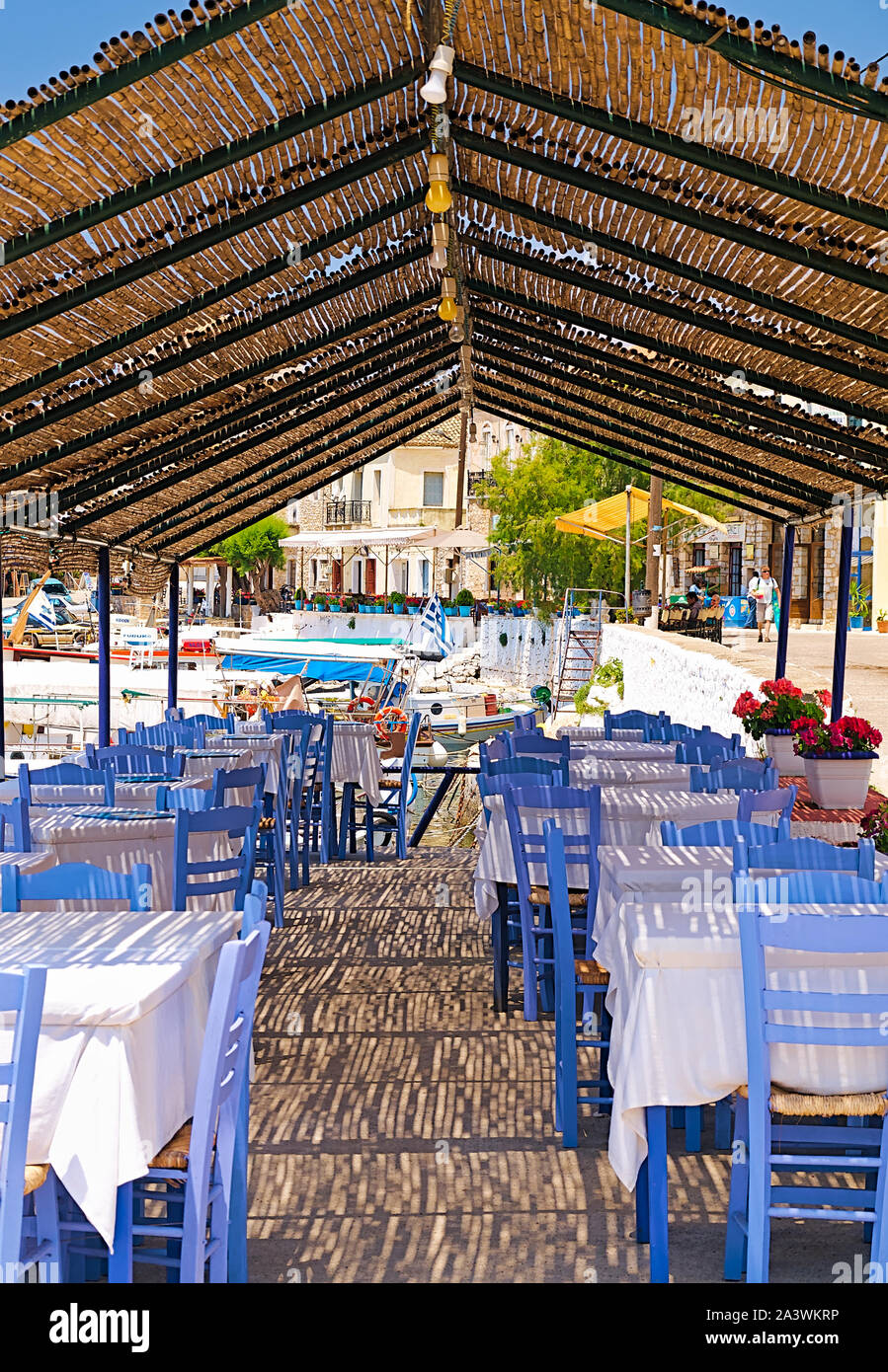 Traditional Greek tavern tables under roof made of reeds Stock Photo ...