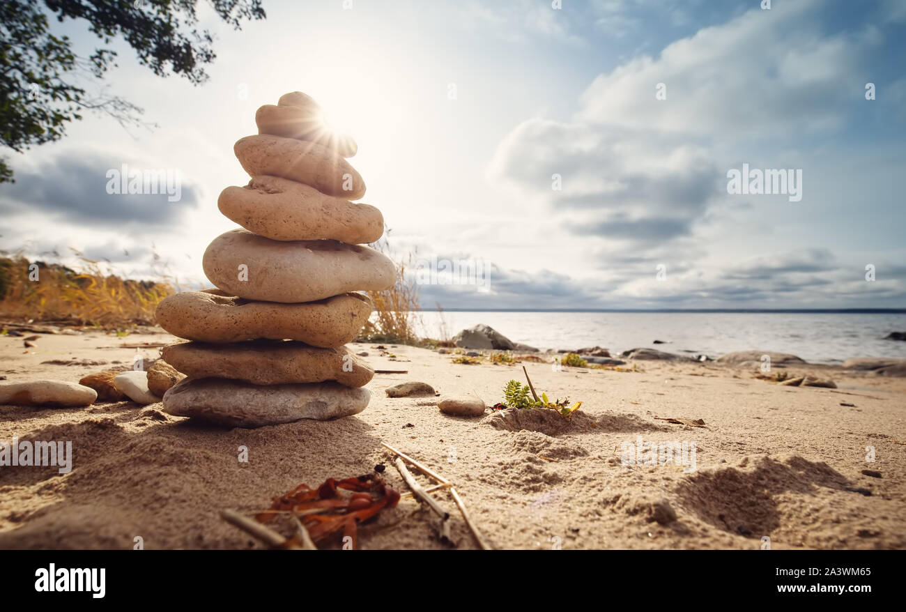 zen stones stacked at sea with backlight Stock Photo - Alamy