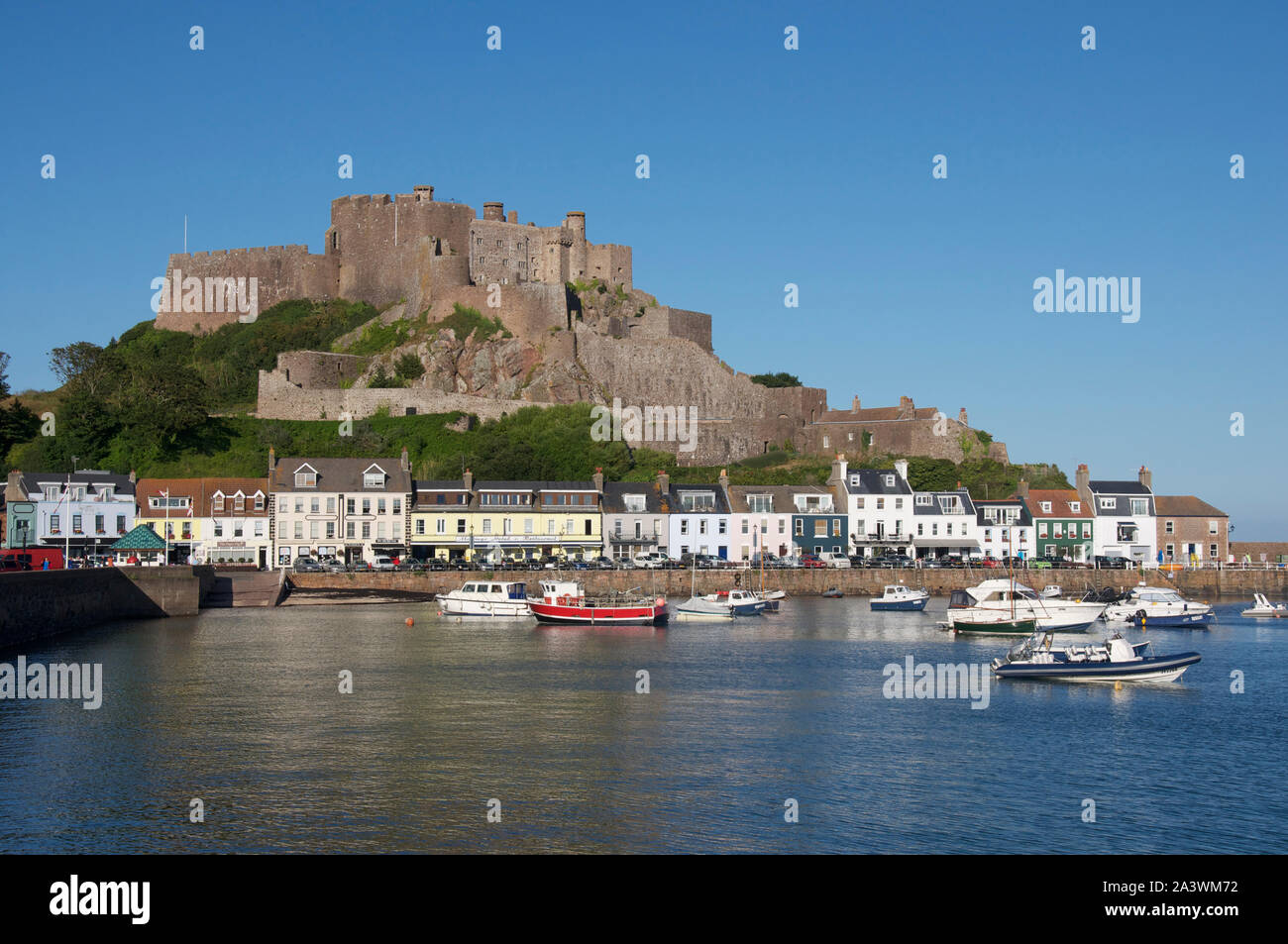 The towering historic medieval stone ramparts of Mont Orgueil Castle ...