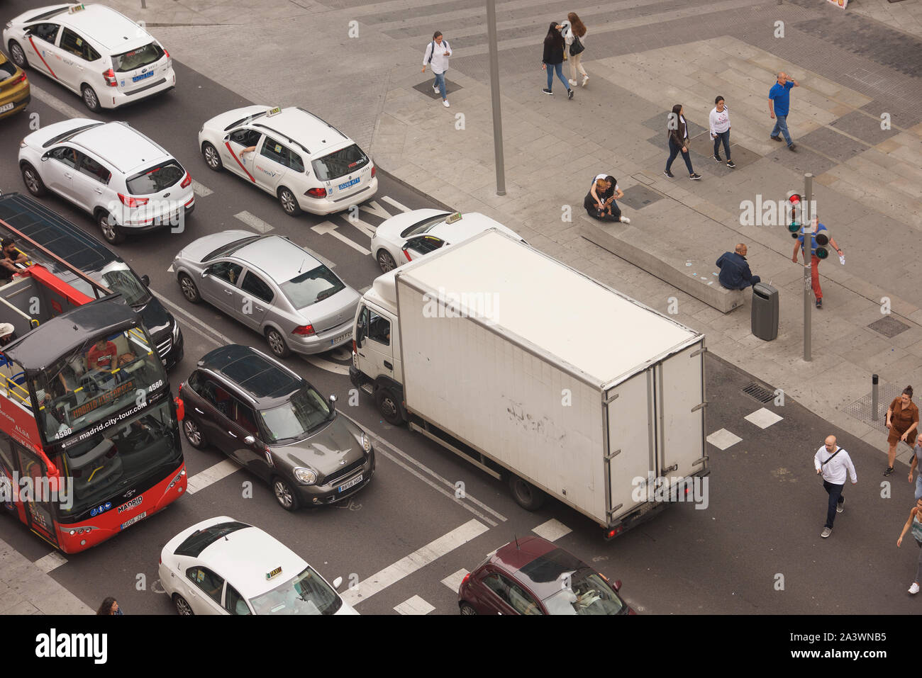 Pedestrians crossing a busy street with road traffic Stock Photo - Alamy
