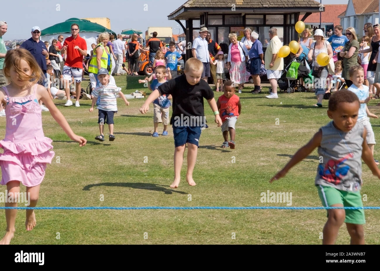 Children in a jumping race at a local fair Stock Photo - Alamy