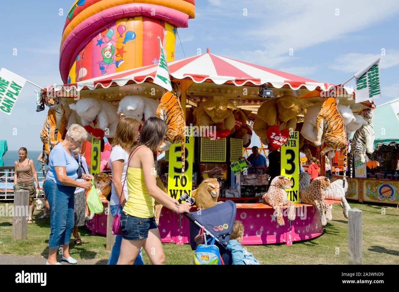 A stall at a fair with two women with buggies walking past Stock Photo ...