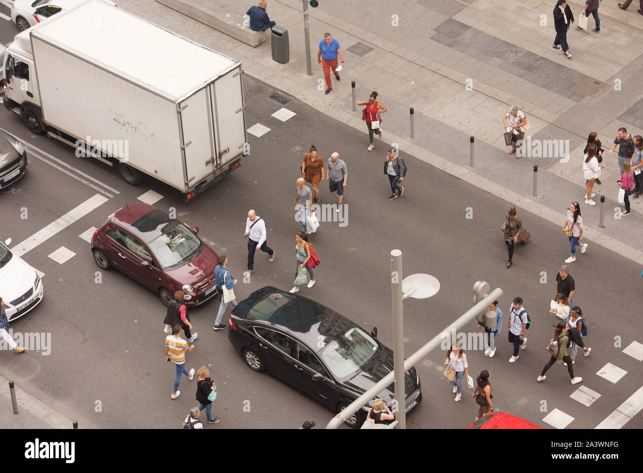 Pedestrians crossing a busy street with road traffic Stock Photo - Alamy