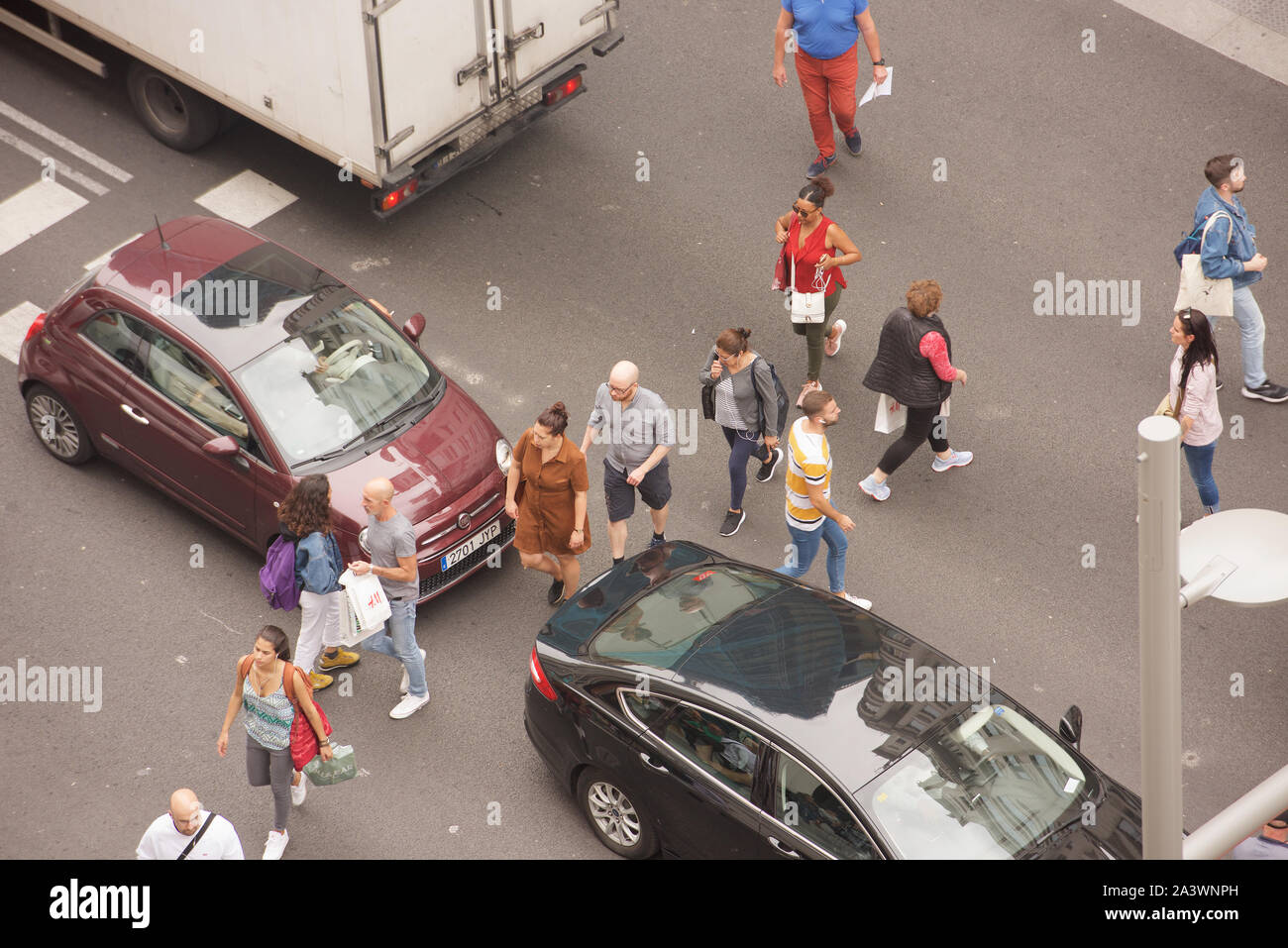 Pedestrians crossing a busy street with road traffic Stock Photo - Alamy