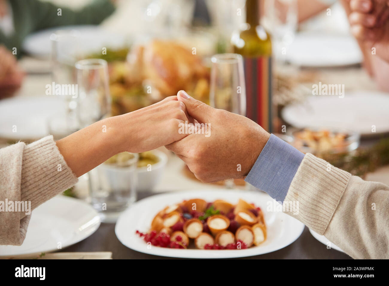 Couple holding hands dinner table hi-res stock photography and images ...
