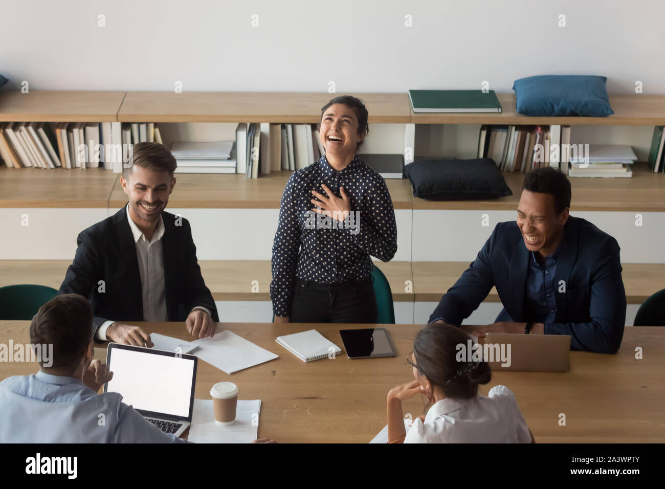 Cheerful indian leader and workers group laughing during corporate ...