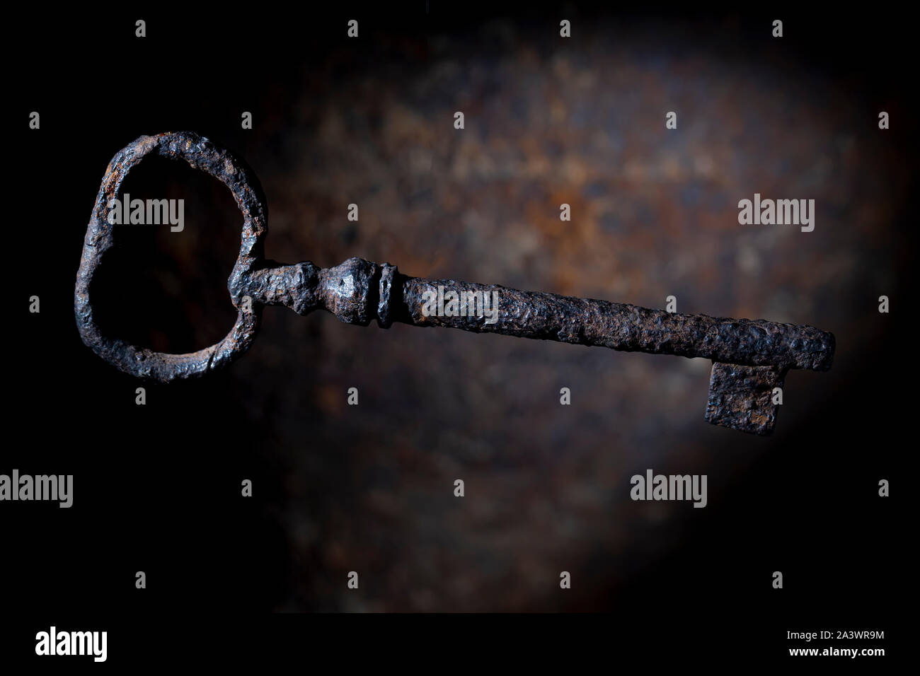 Rusty vintage key on a dark corrosion background Stock Photo - Alamy