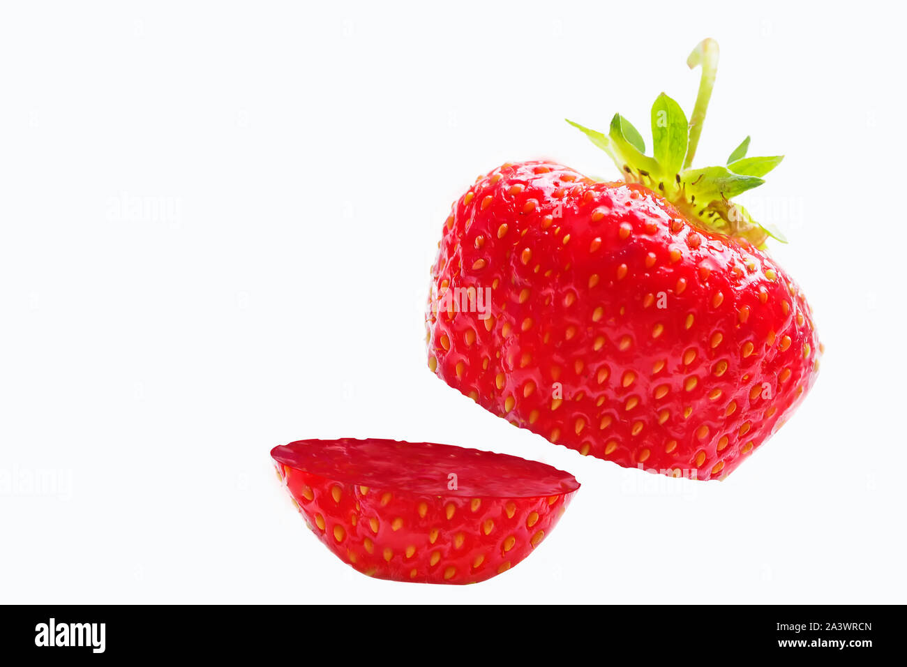 Sliced strawberries. Single strawberry fruit isolated on white ...