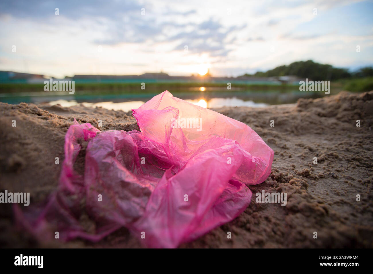 Cellophane package on the river bank. Environmental pollution.Garbage ...
