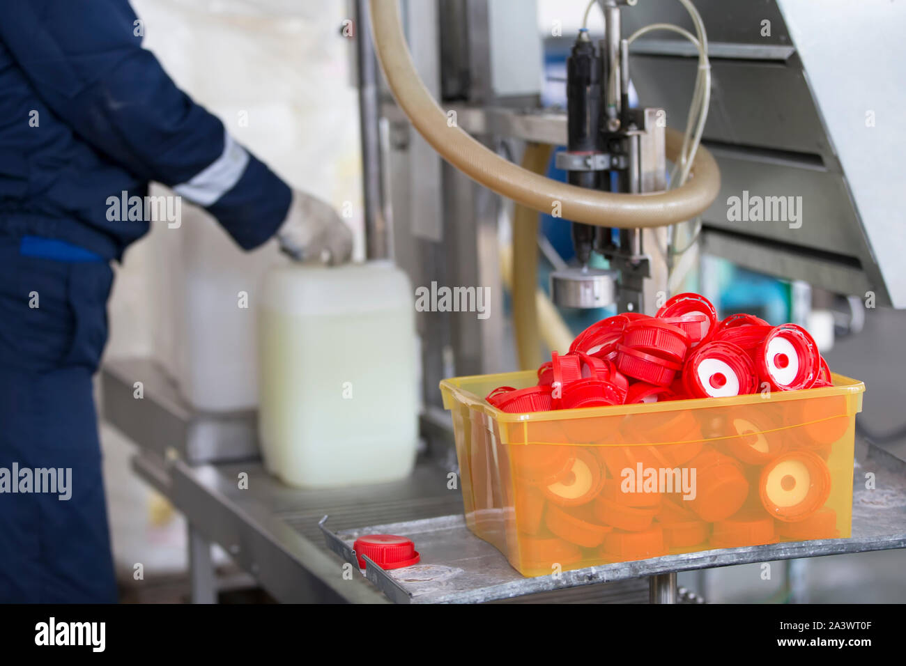 Industrial container for bottling and packaging chemicals.Hands of a ...