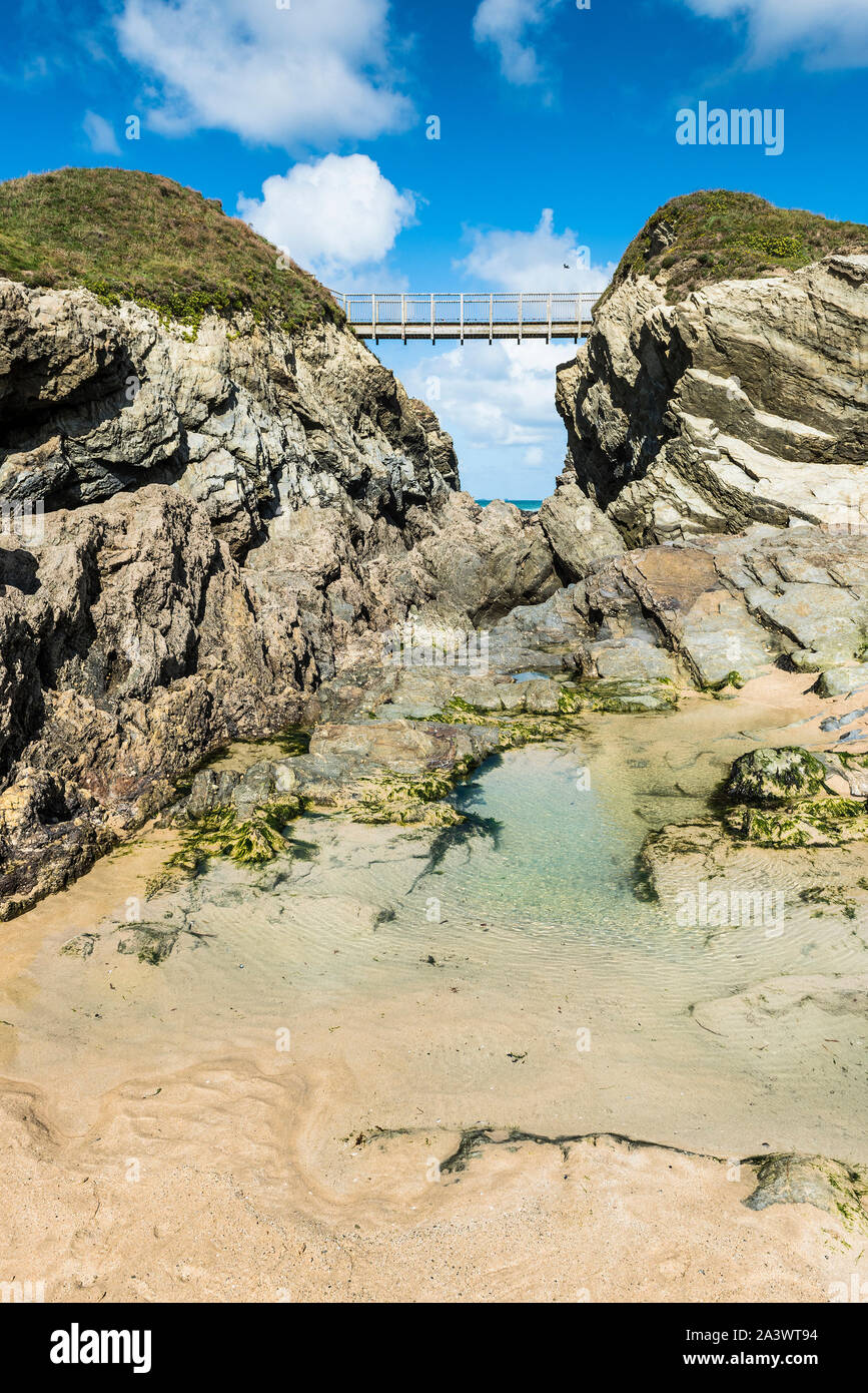 The footbridge connecting the mainland to Porth Island at Porth Beach ...