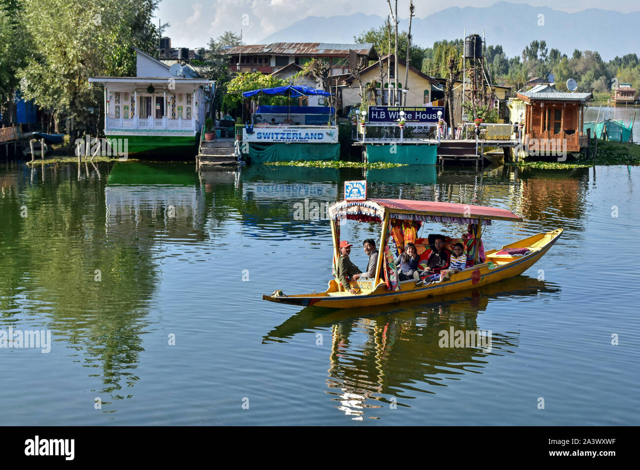Indian tourists enjoy a shikara boat ride on the waters of the world famous Dal lake in Kashmir ...