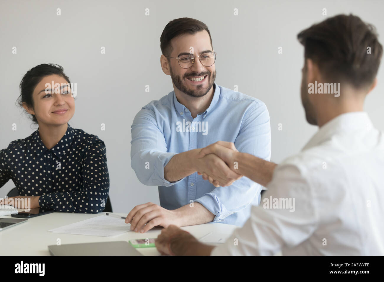 Smiling male hr manager handshake applicant at job interview Stock ...