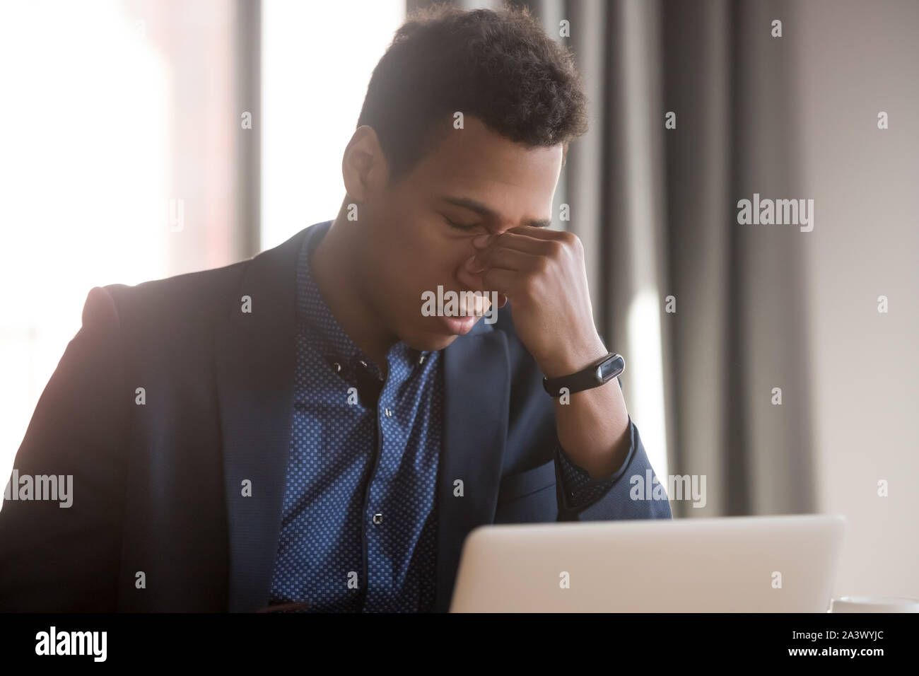 Frustrated stressed black businessman feel eye strain headache at work ...