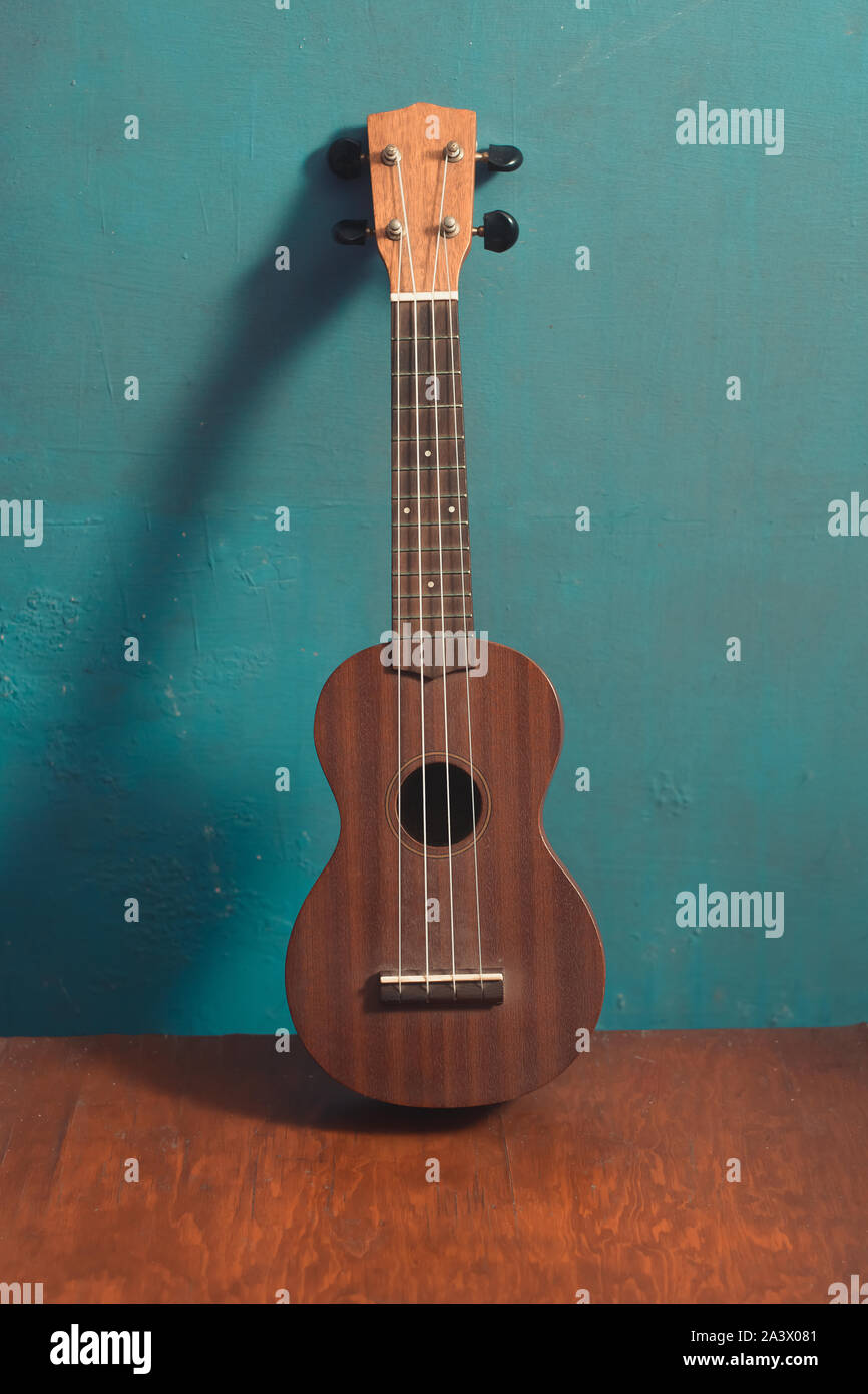 ukulele on wood with isolated blue background, front view Stock Photo ...