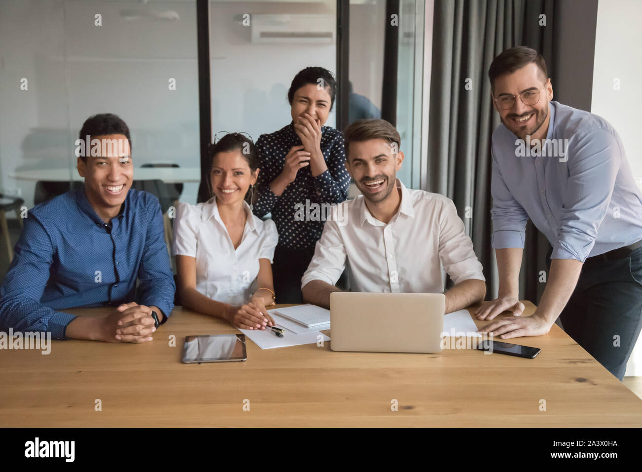 Cheerful multiethnic professional business team posing together at ...