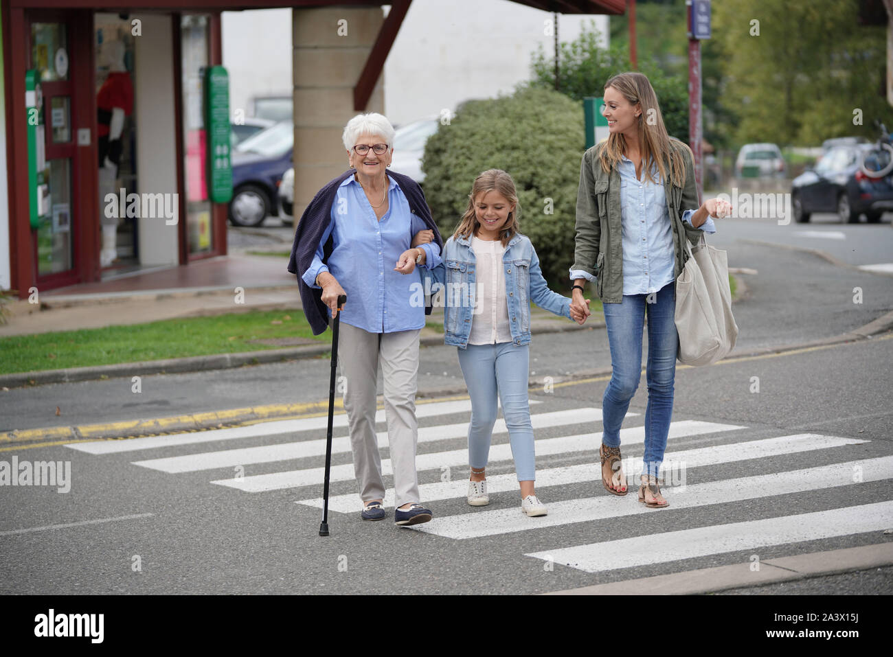Grandmother, mother and daughter crossing the street Stock Photo - Alamy
