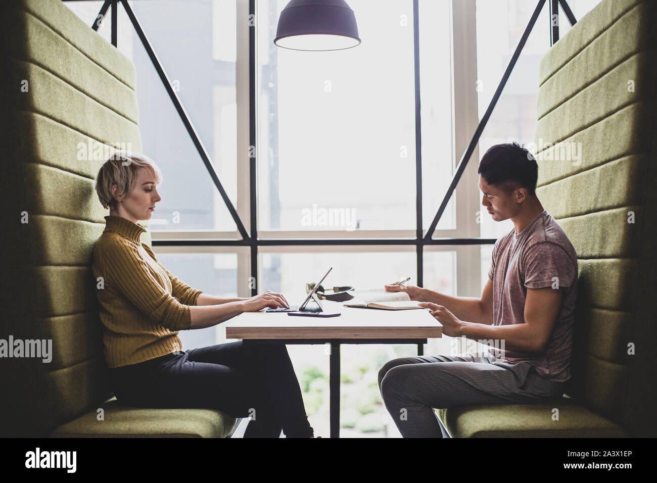 Coworkers working in a cafe Stock Photo - Alamy