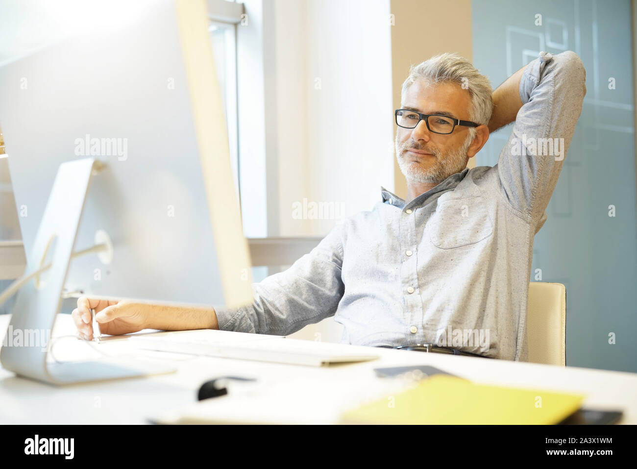 Boss sitting behind desk hi-res stock photography and images - Alamy