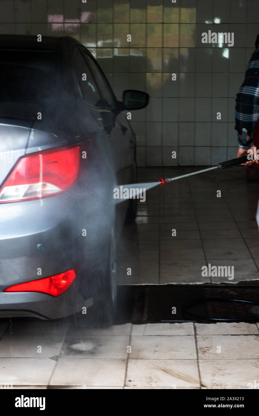 Gray car wash with water at a car wash. Contactless sink. Car wash ...