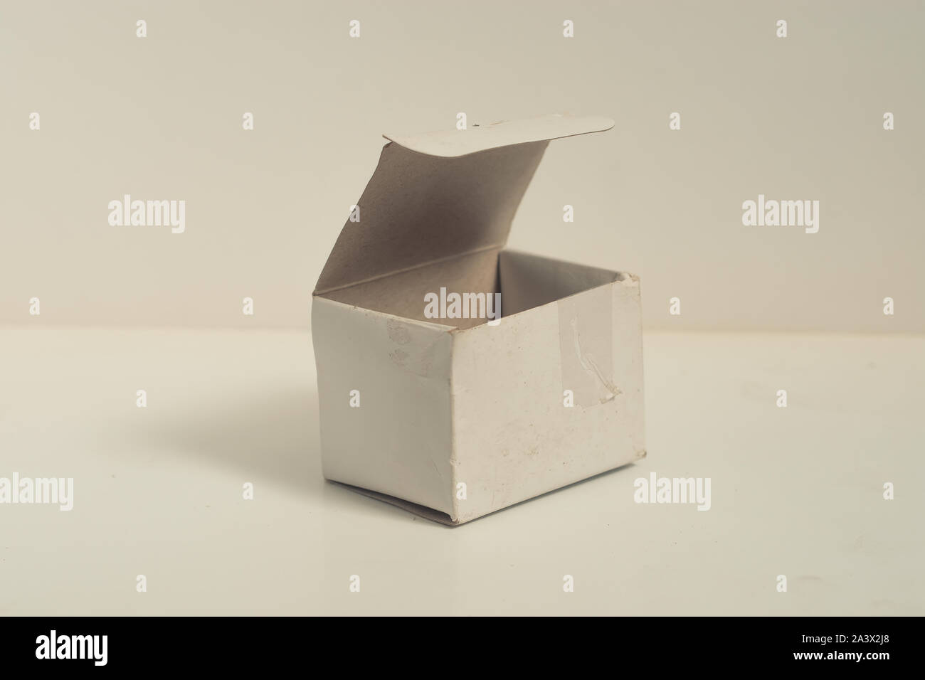 Small open square cardboard box on isolated white background, designed ...