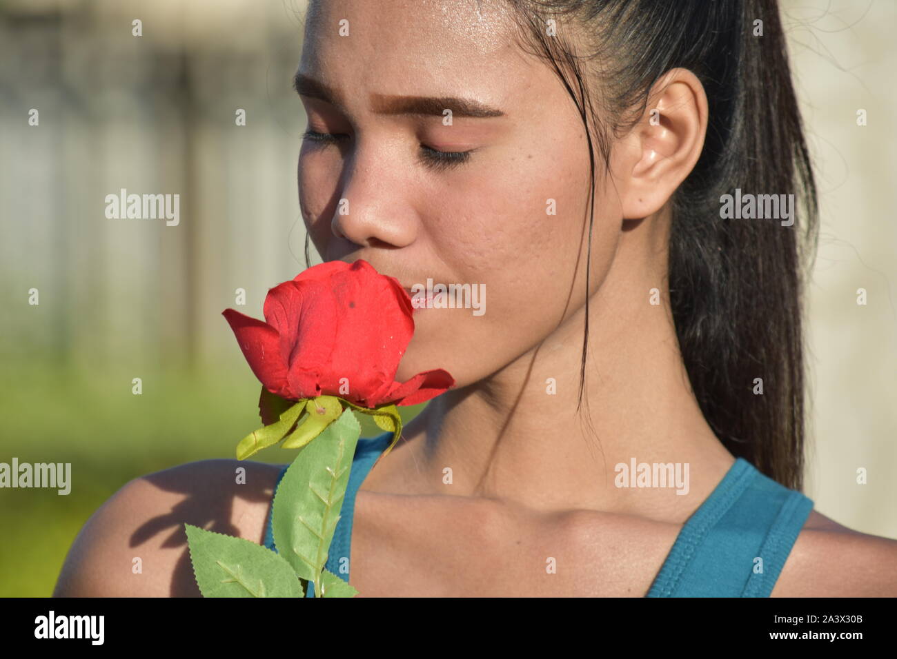 Youthful Filipina Person With Smelling Roses Stock Photo - Alamy