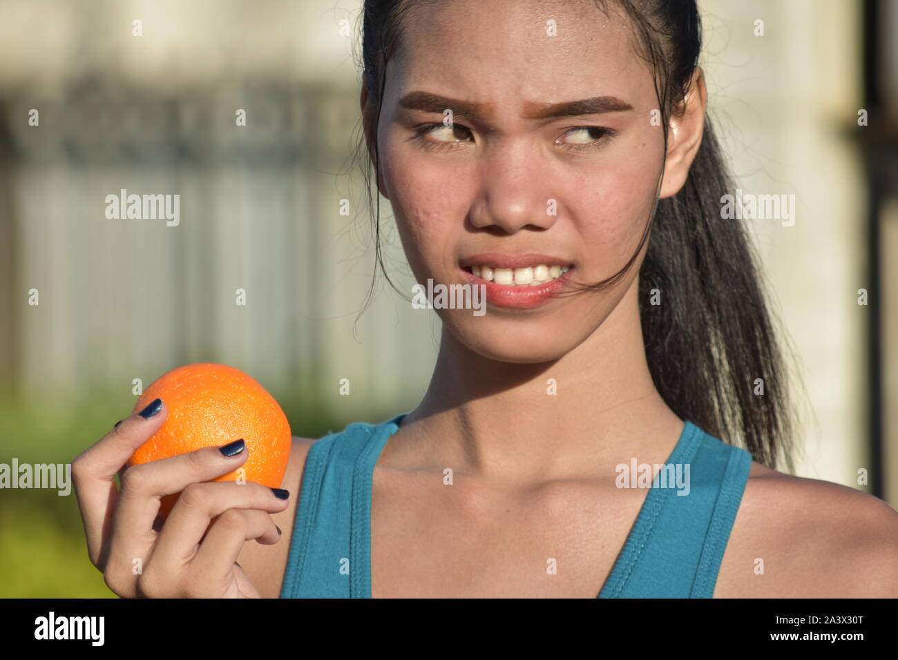 Unhappy Pretty Minority Person With Orange Stock Photo - Alamy