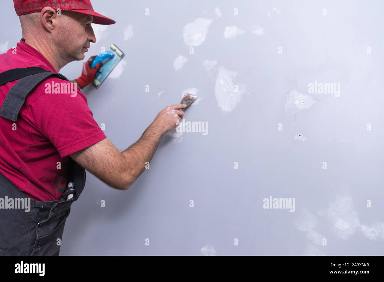 Professional painter with roller. Renovation Stock Photo - Alamy
