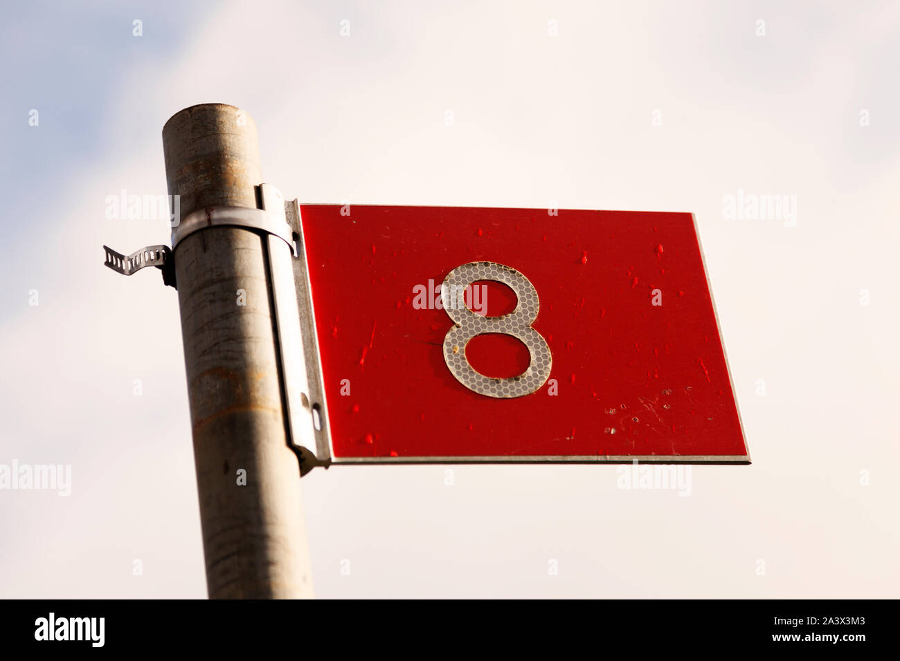 sign with the number eight, red with white text Stock Photo - Alamy