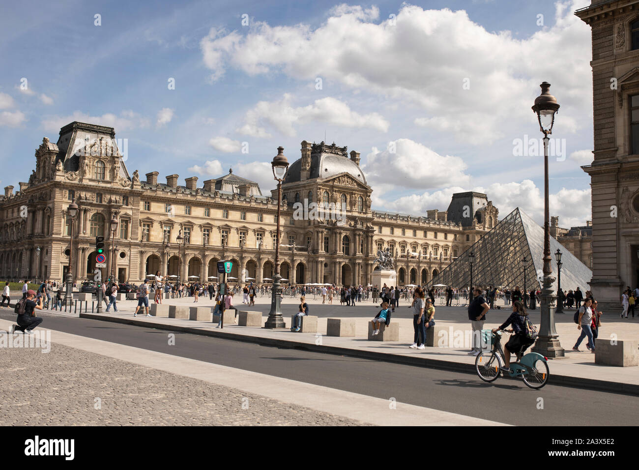 The main courtyard (Cour Napoleon) of the Louvre palace museum, with ...