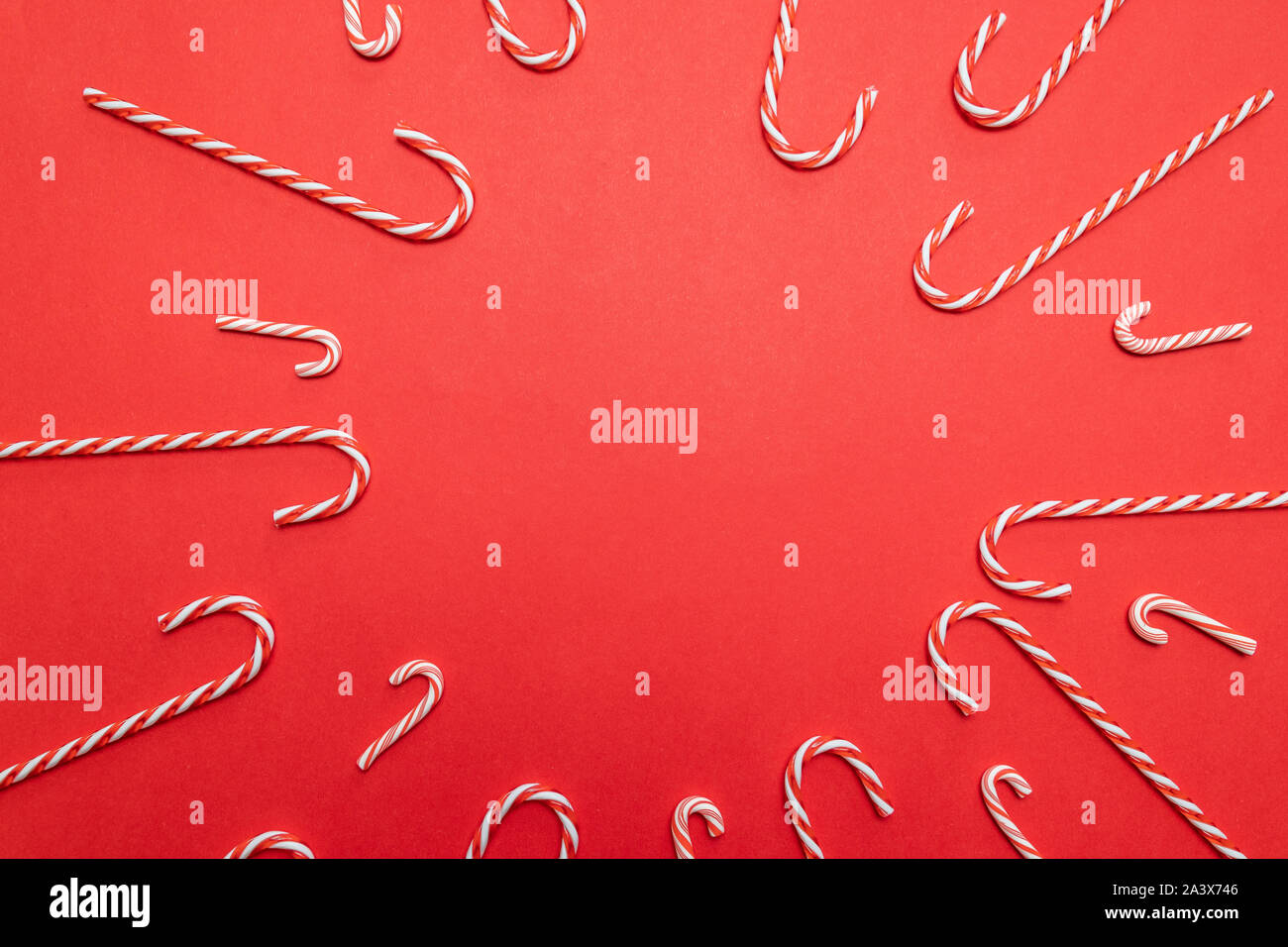 Merry Christmas banner with frame of candy canes on red background ...