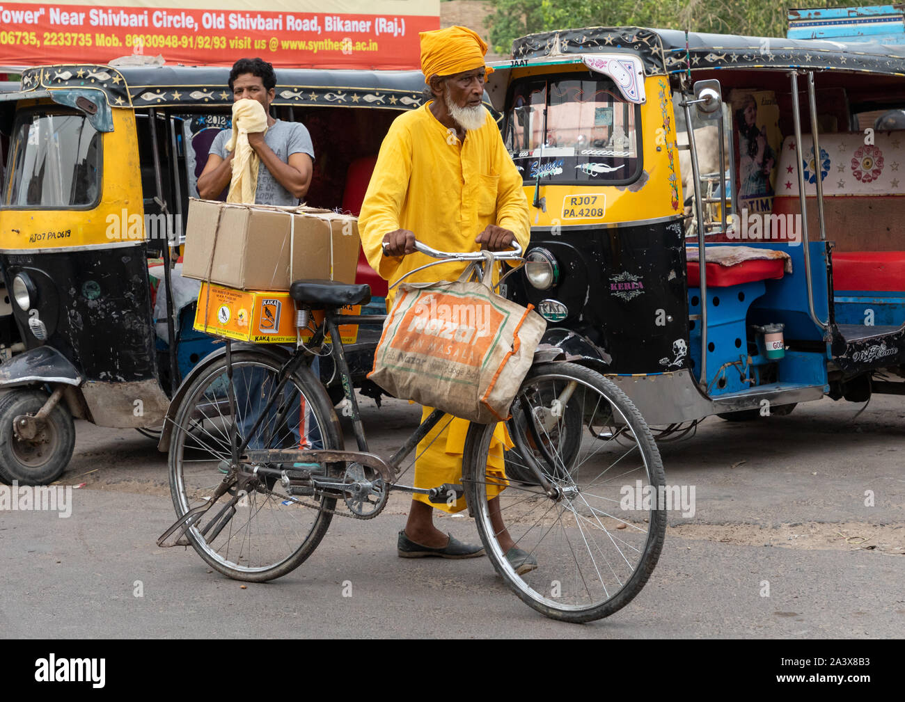 Indian priest with his bicycle in the street, Rajasthan, Bikaner, India ...