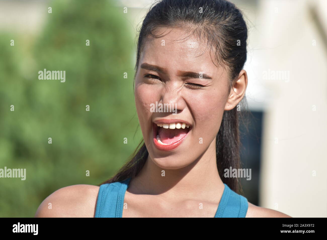 Pretty Female Winking Stock Photo - Alamy