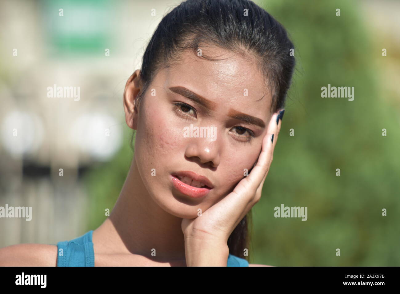 An Unhappy Filipina Woman Stock Photo - Alamy